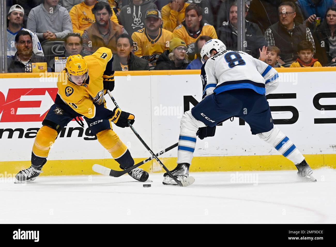 Nashville Predators center Cody Glass, left, takes the puck away from ...