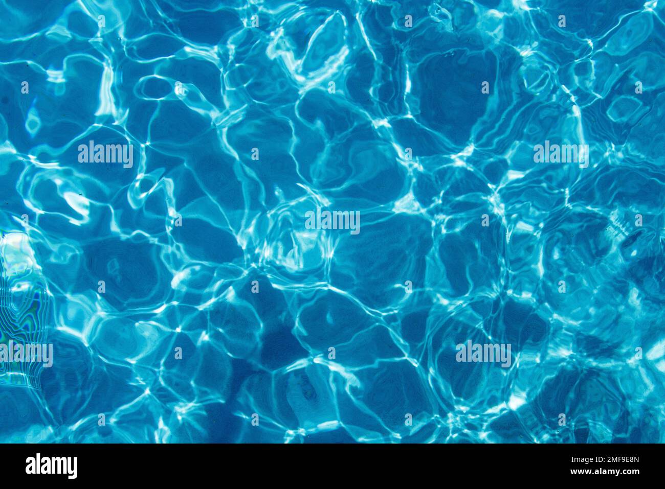 Sunlight reflected in a clear blue pool in summer Stock Photo - Alamy