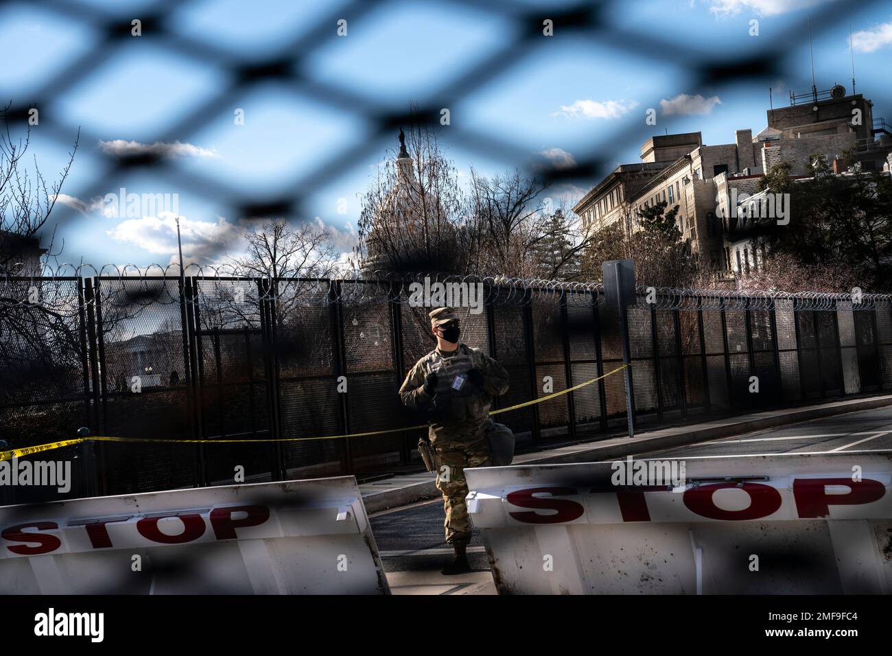 Members of the military stand guard at a checkpoint as security is ...