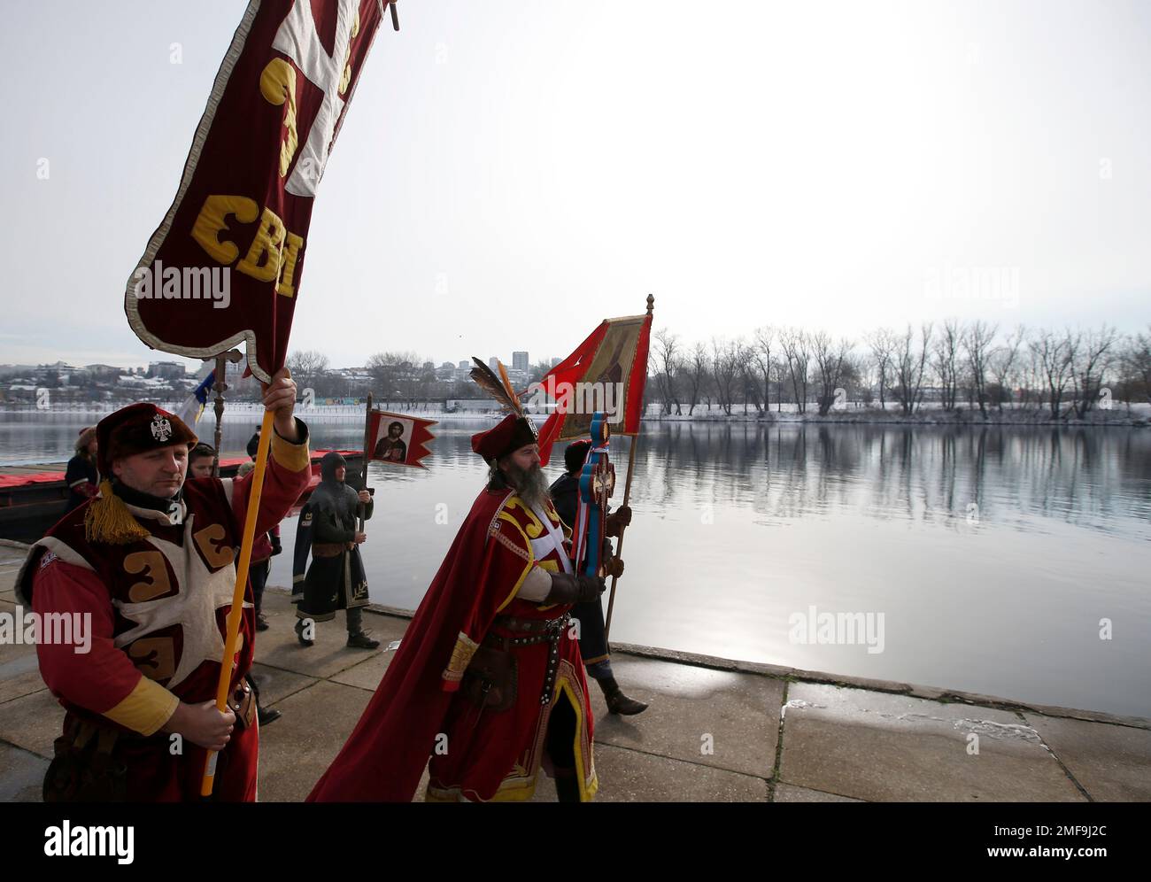 People wearing traditional costumes, walk, during the celebrations of ...