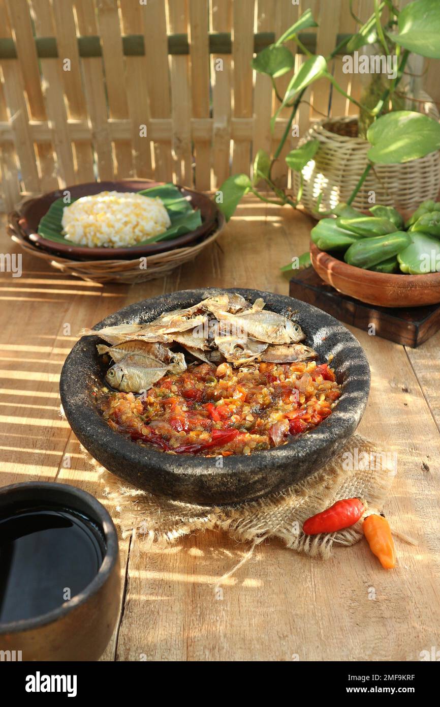 Fried salted fish with chili sauce served on a stone mortar Stock Photo ...