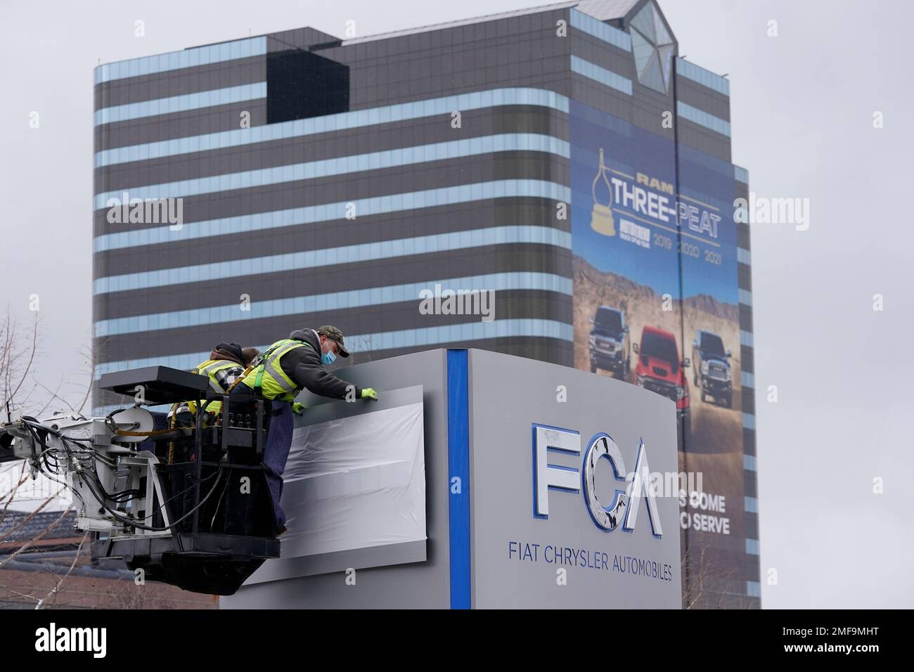 A crew begins changing the signage outside the Chrysler Technology ...
