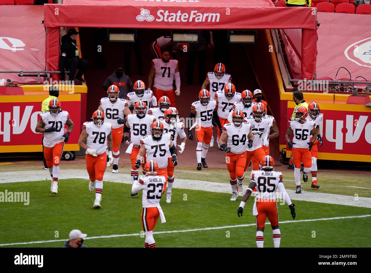 Cleveland Browns players run onto the field before an NFL divisional ...