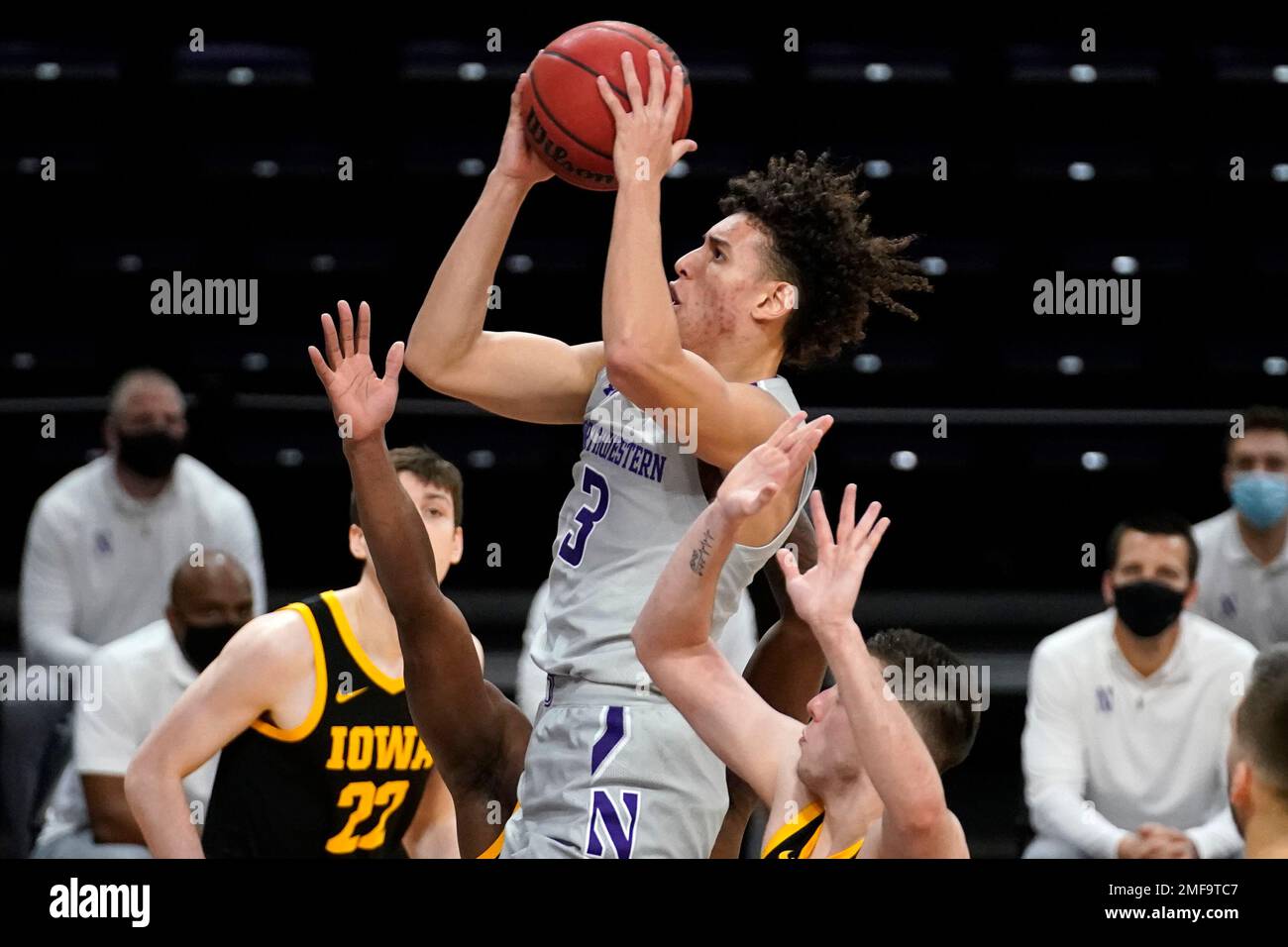 Northwestern guard Ty Berry drives to the basket against Iowa during ...