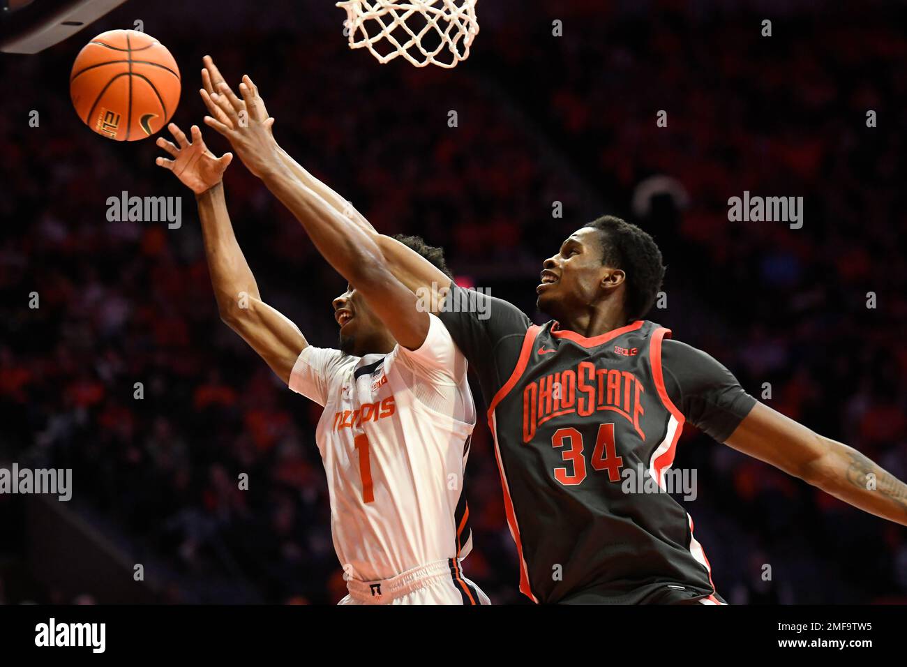 Ohio State's Felix Okpara (34) and Illinois' Sencire Harris (1) reach ...