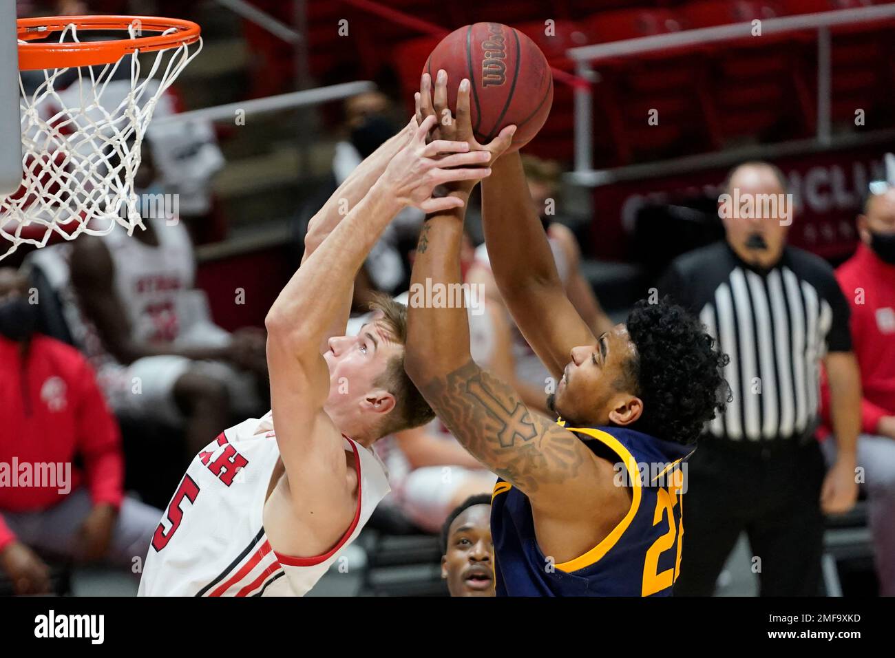 Utah center Branden Carlson, left, and California forward Andre Kelly ...