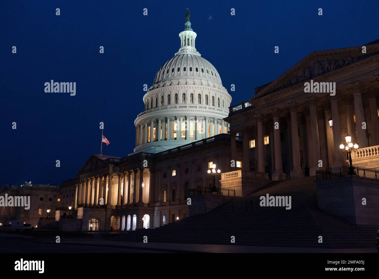 The moon rises behind the U.S. Capitol Saturday, Jan. 16, 2021, in ...