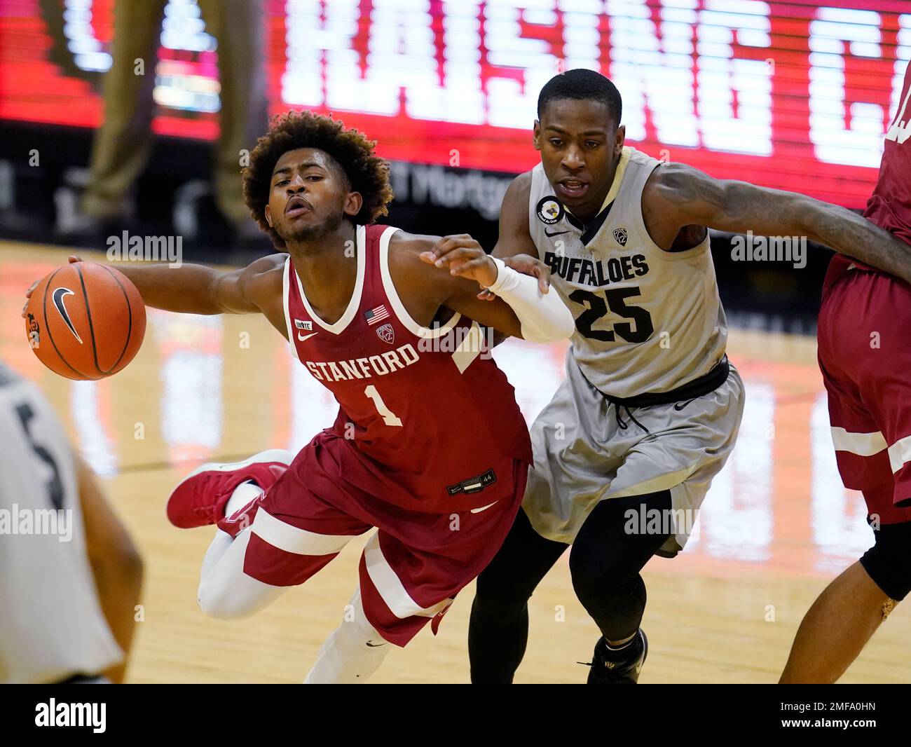 Stanford guard Daejon Davis, left, drives past Colorado guard McKinley ...