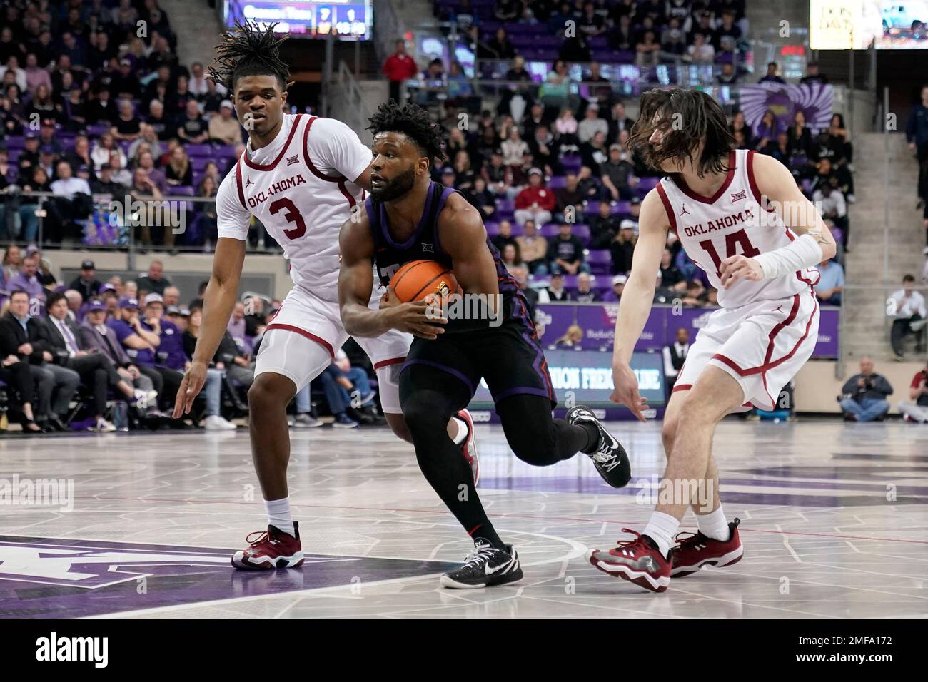 TCU guard Mike Miles Jr., center, drives to the basket between Oklahoma ...
