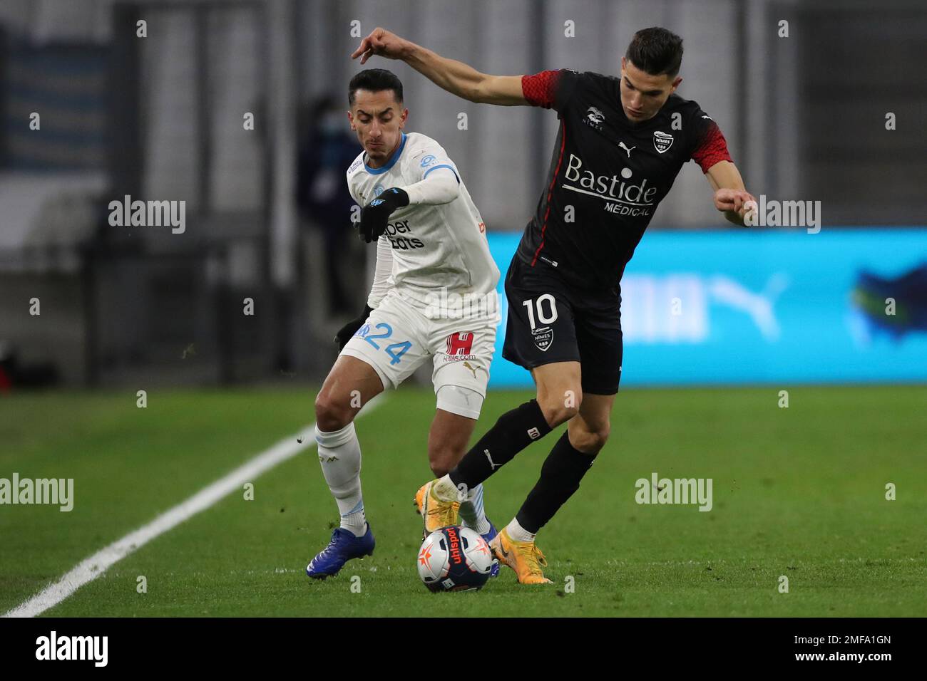 Marseille's Saif-Eddine Khaoui, left, vie for the ball with Nimes ...