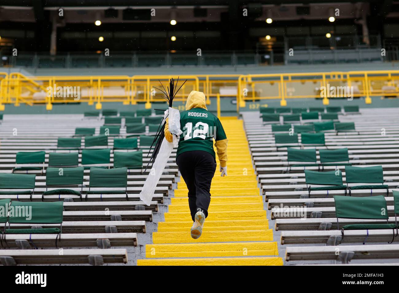 A stadium worker walks inside Lambeau Field before an NFL divisional ...