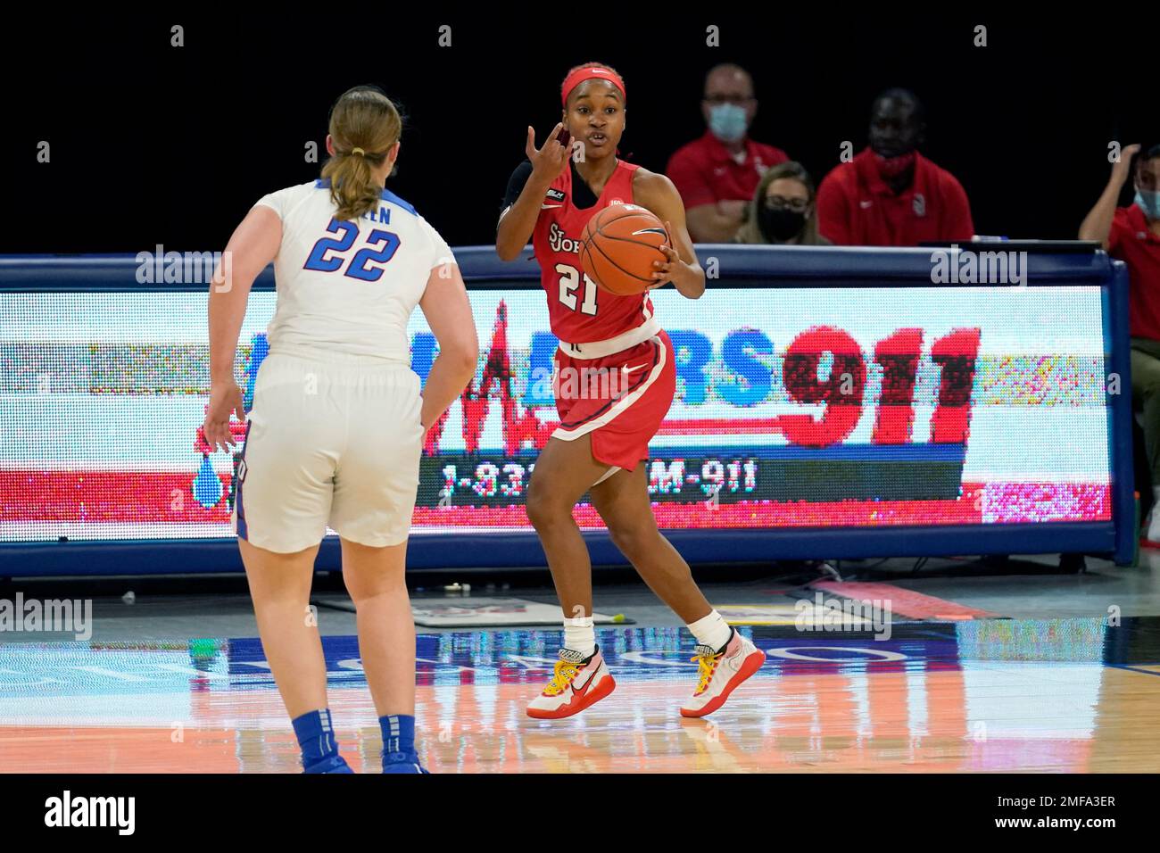 St. John's guard Qadashah Hoppie, right, talks to teammates as she ...
