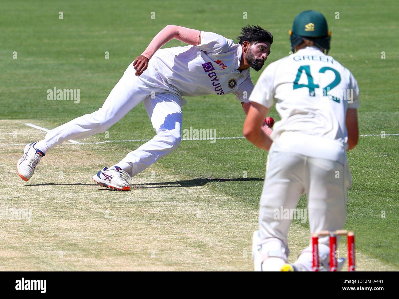 India's Mohammed Siraj fields the ball after bowling to Australia's ...