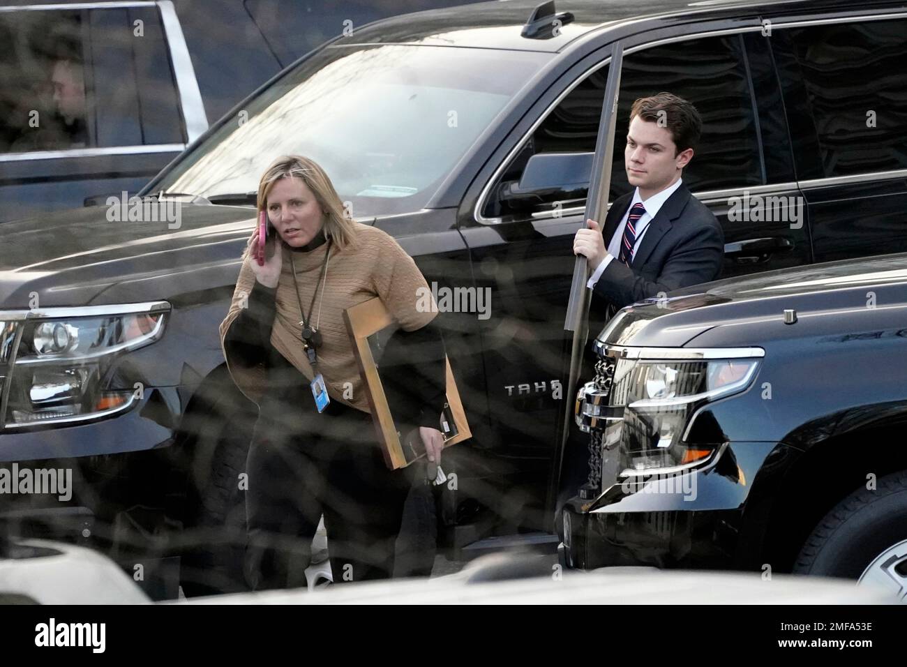 People leave the Eisenhower Executive Office building with framed items ...