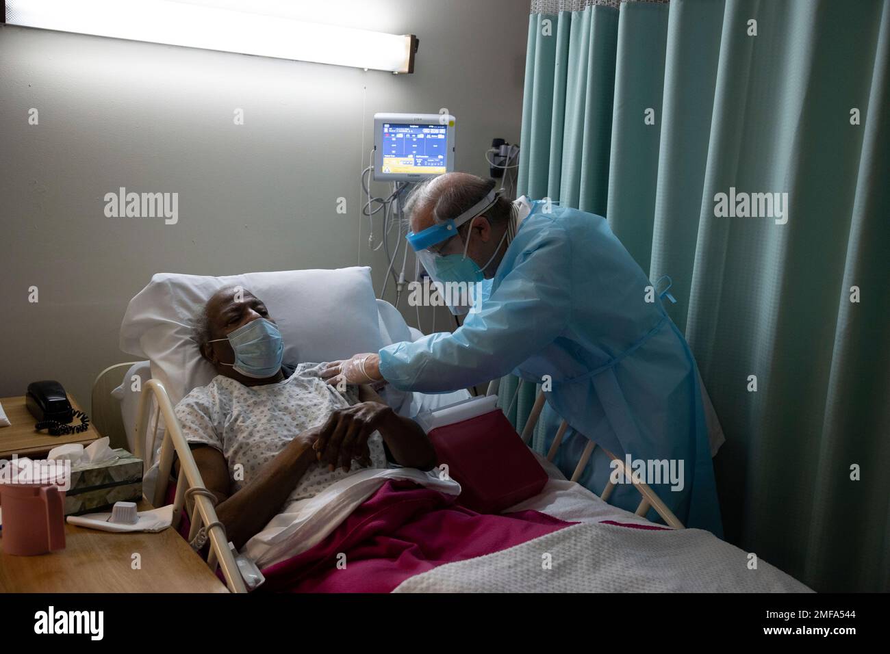 CVS Pharmacist Gerard Diebner administers the COVID-19 vaccine to a ...