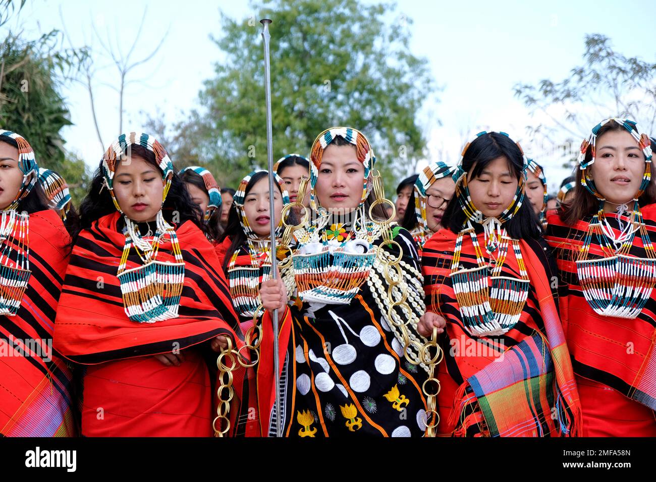 A young Tangkhul Naga bride-to-be, in traditional attire, center, walks ...