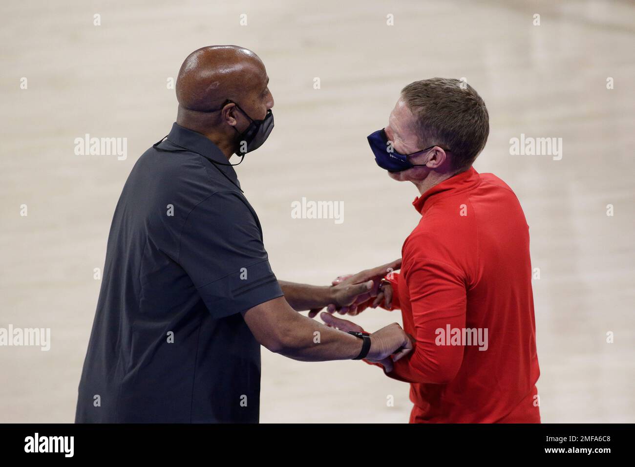 Pepperdine head coach Lorenzo Romar, left, and Gonzaga head coach Mark ...