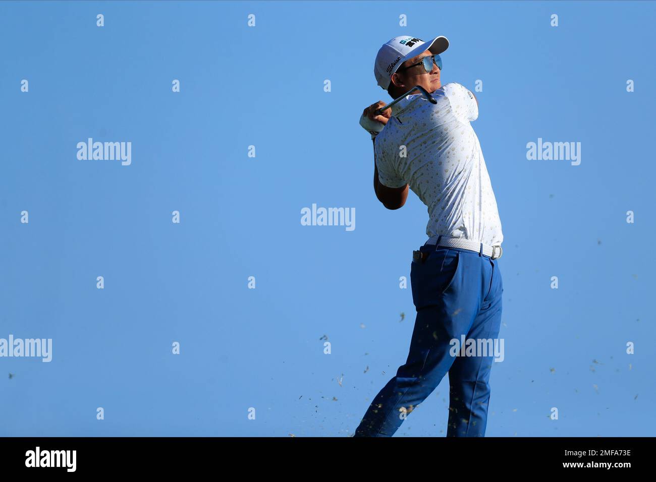 C.T. Pan, of Taiwan, follows through on his shot from the 17th tee box ...