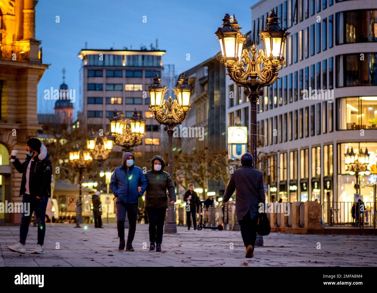 People wearing face masks walk through downtown Frankfurt, Germany ...