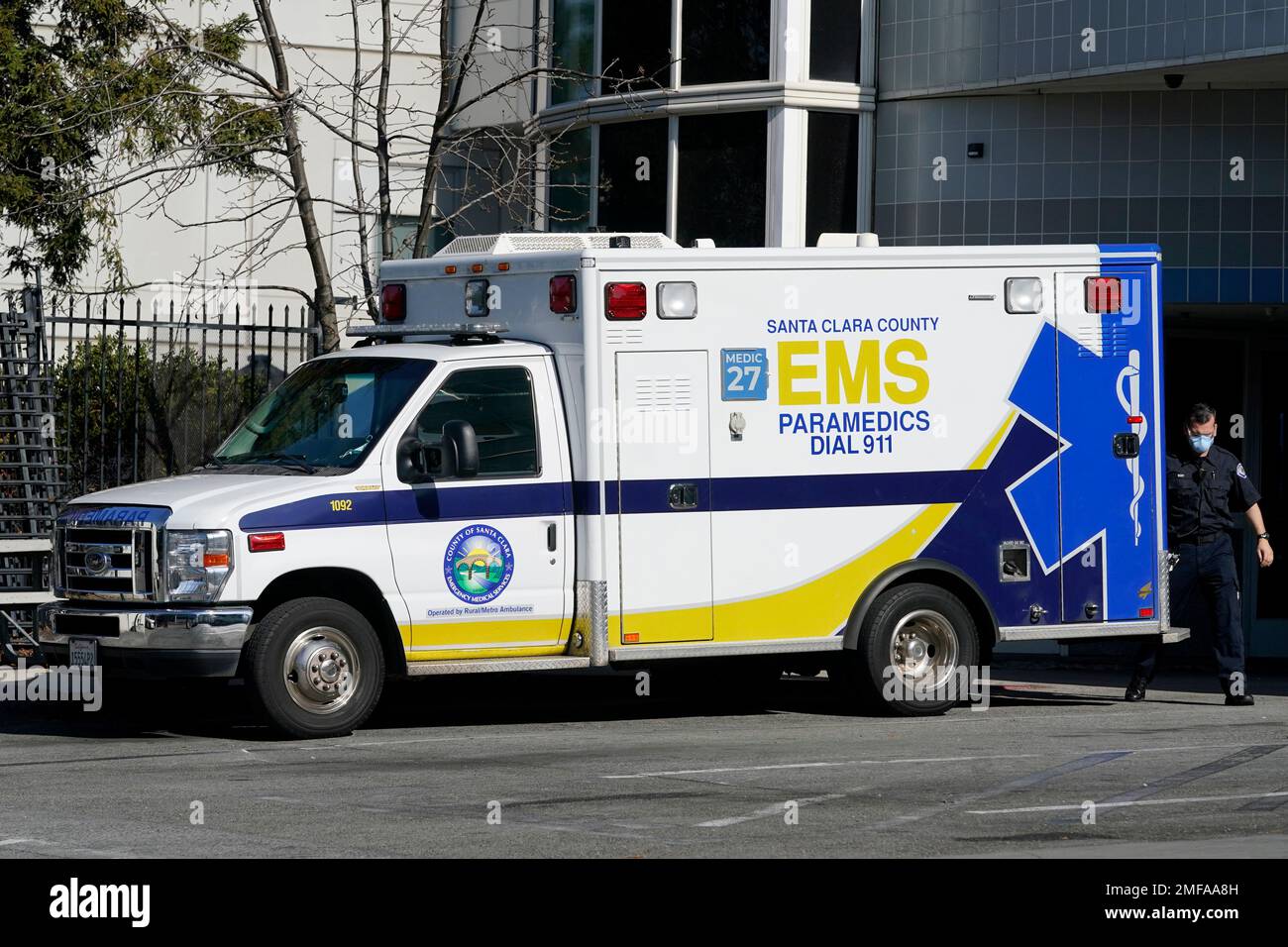 A medic walks behind an ambulance outside of Santa Clara Valley Medical ...
