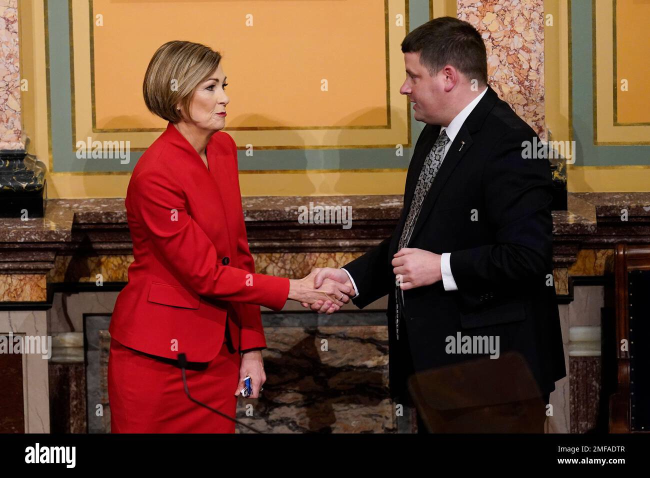 Iowa Gov. Kim Reynolds greets Iowa House Speaker Pat Grassley, right ...