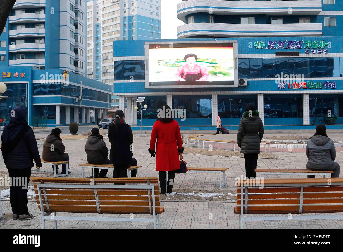 People look at the news on screen in Mirae Scientists Street in ...
