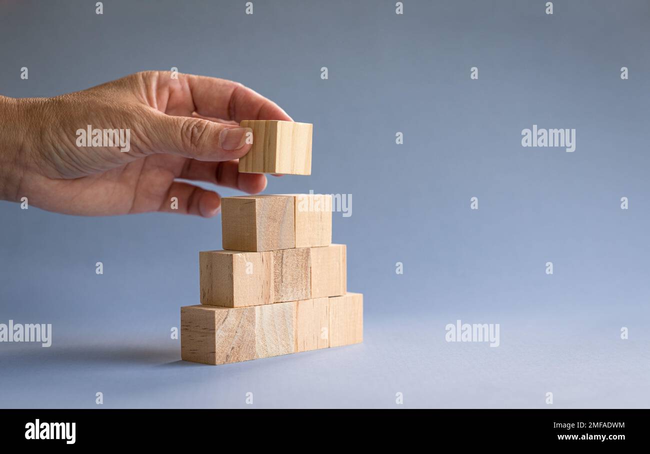 Hand stacking wood blocks. Business growth or team work concept, copy ...