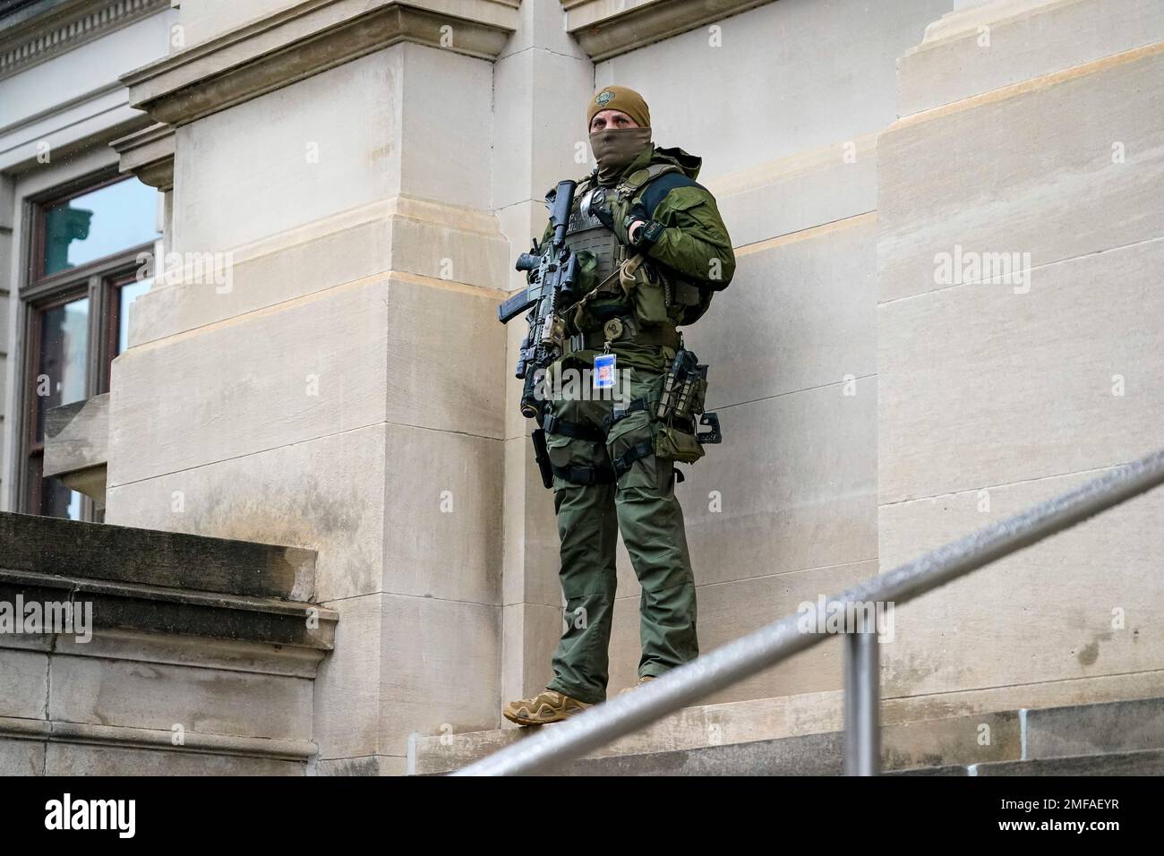 A member of the Georgia State Patrol SWAT team looks on as people walk ...