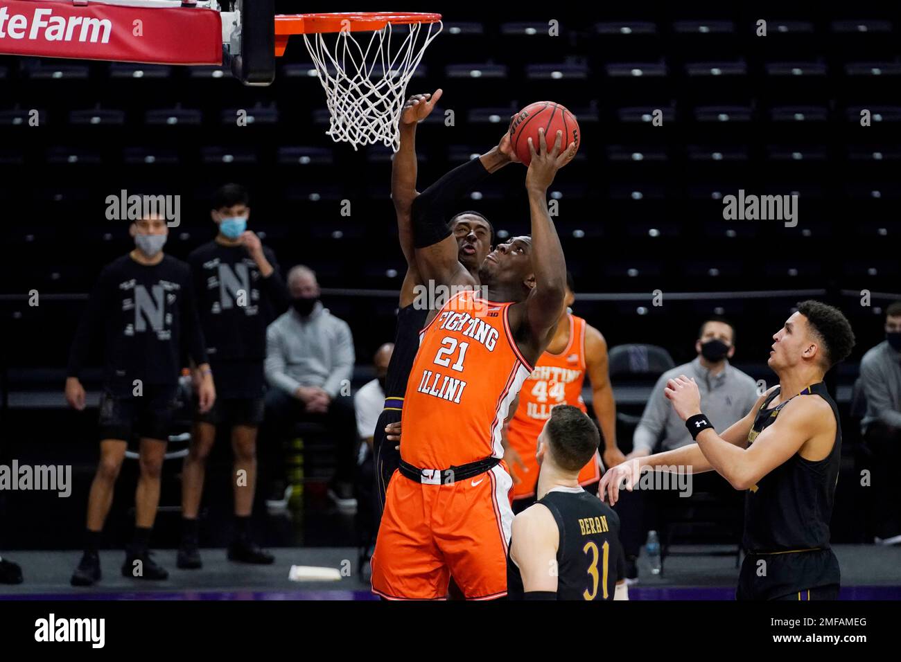 Illinois center Kofi Cockburn, right, goes up for a shot against ...