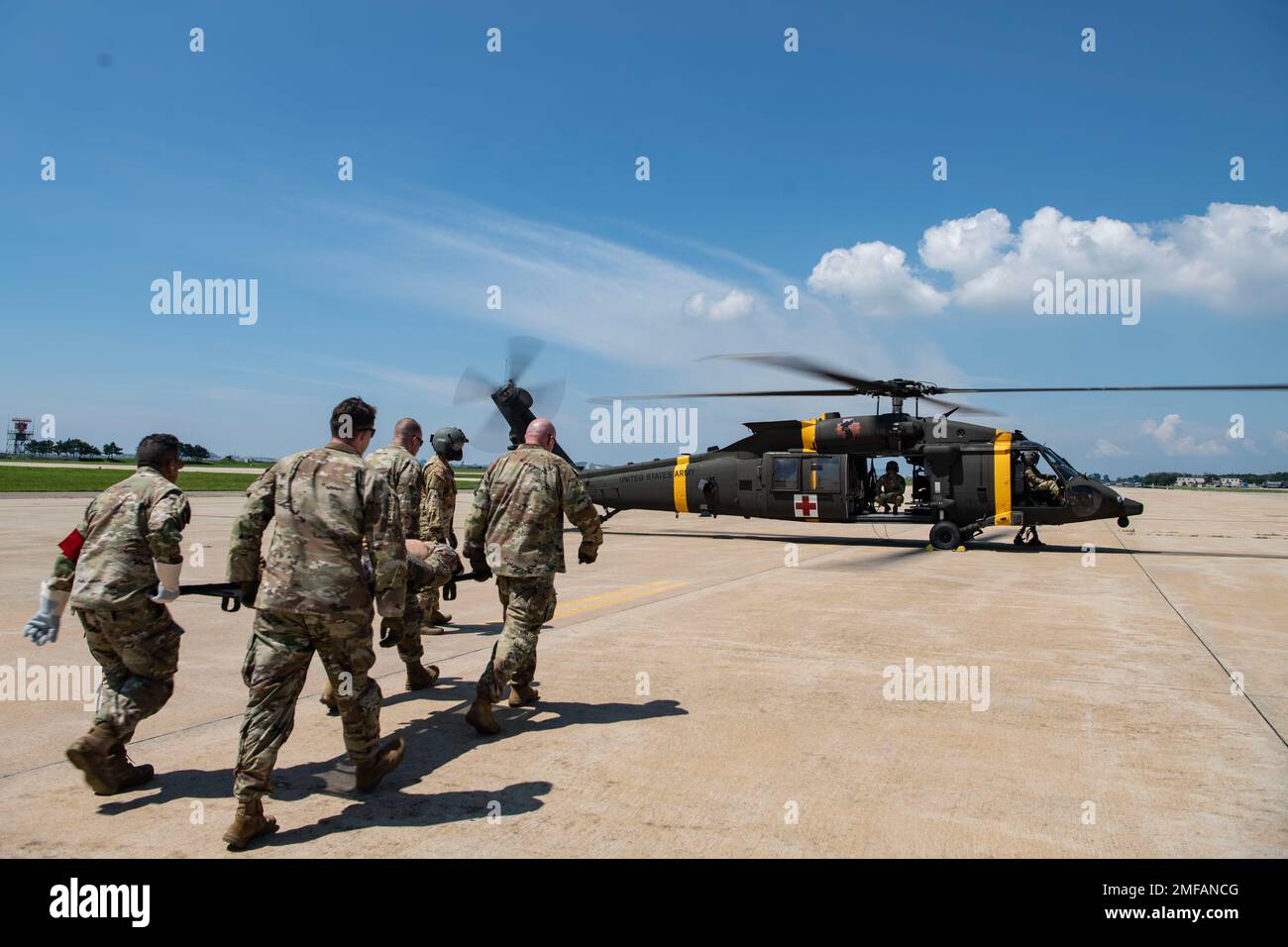 Airmen with the 8th Medical Group perform a litter carry to a UH-60 ...