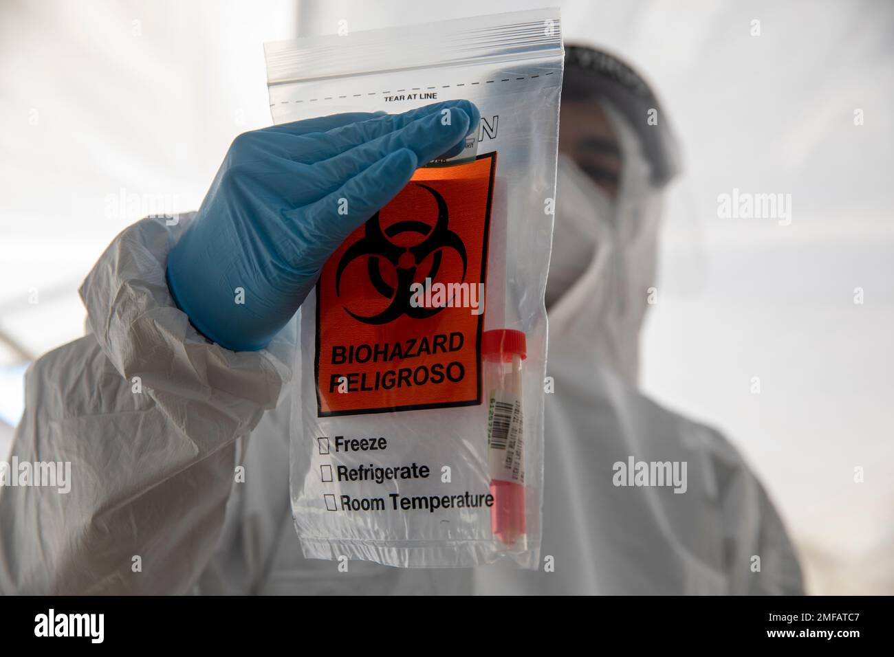 An Israeli health care professional holds a COVID-19 test sample in a ...