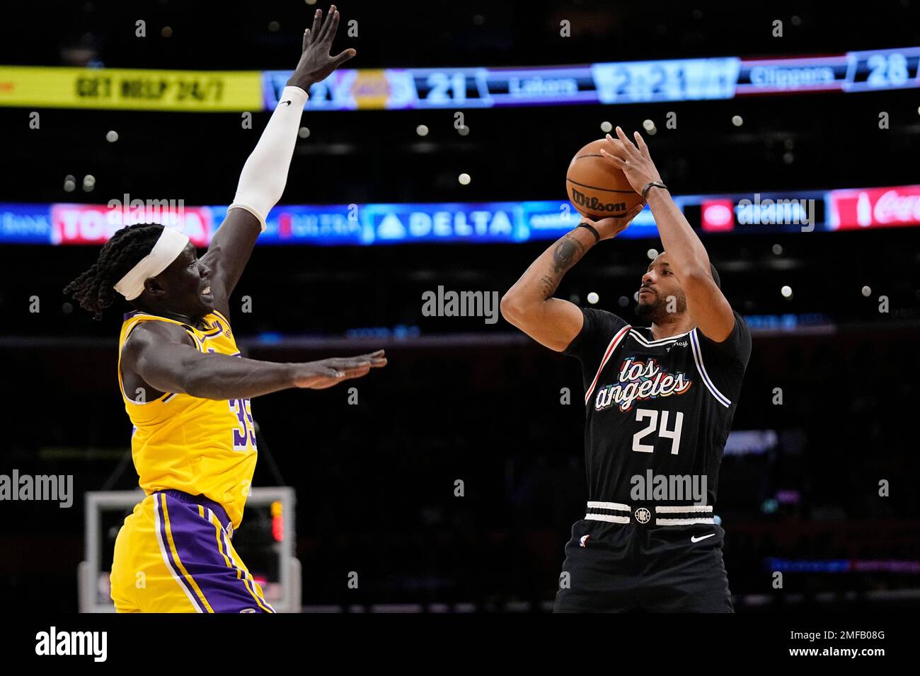 Los Angeles Clippers forward Norman Powell, right, shoots as Los ...