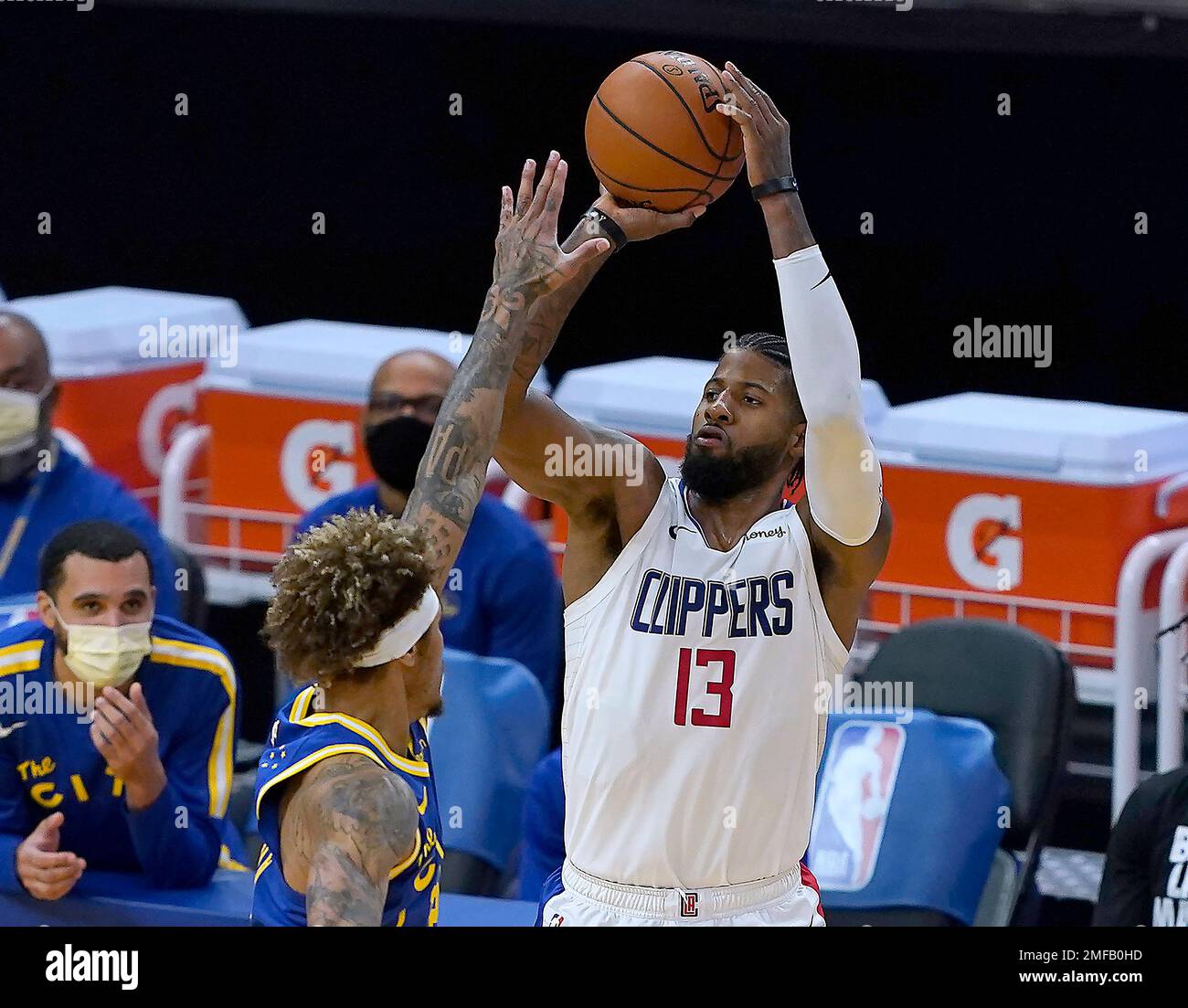 Los Angeles Clippers guard Paul George (13) takes a 3-point shot over ...