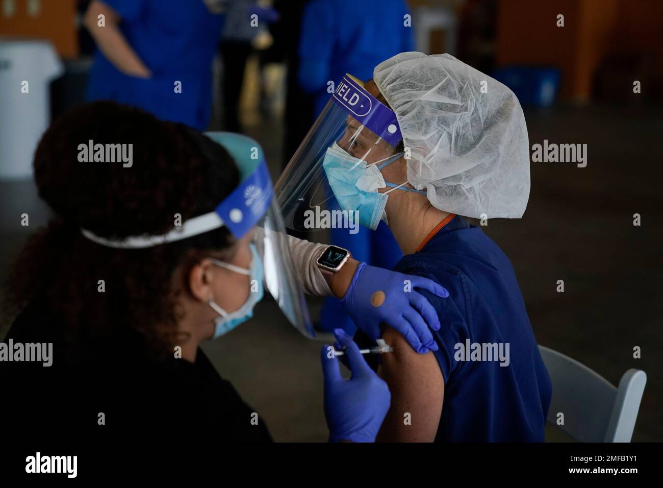 Registered nurse Kimberly Sateri gets the Pfizer-BioNTech COVID-19 ...