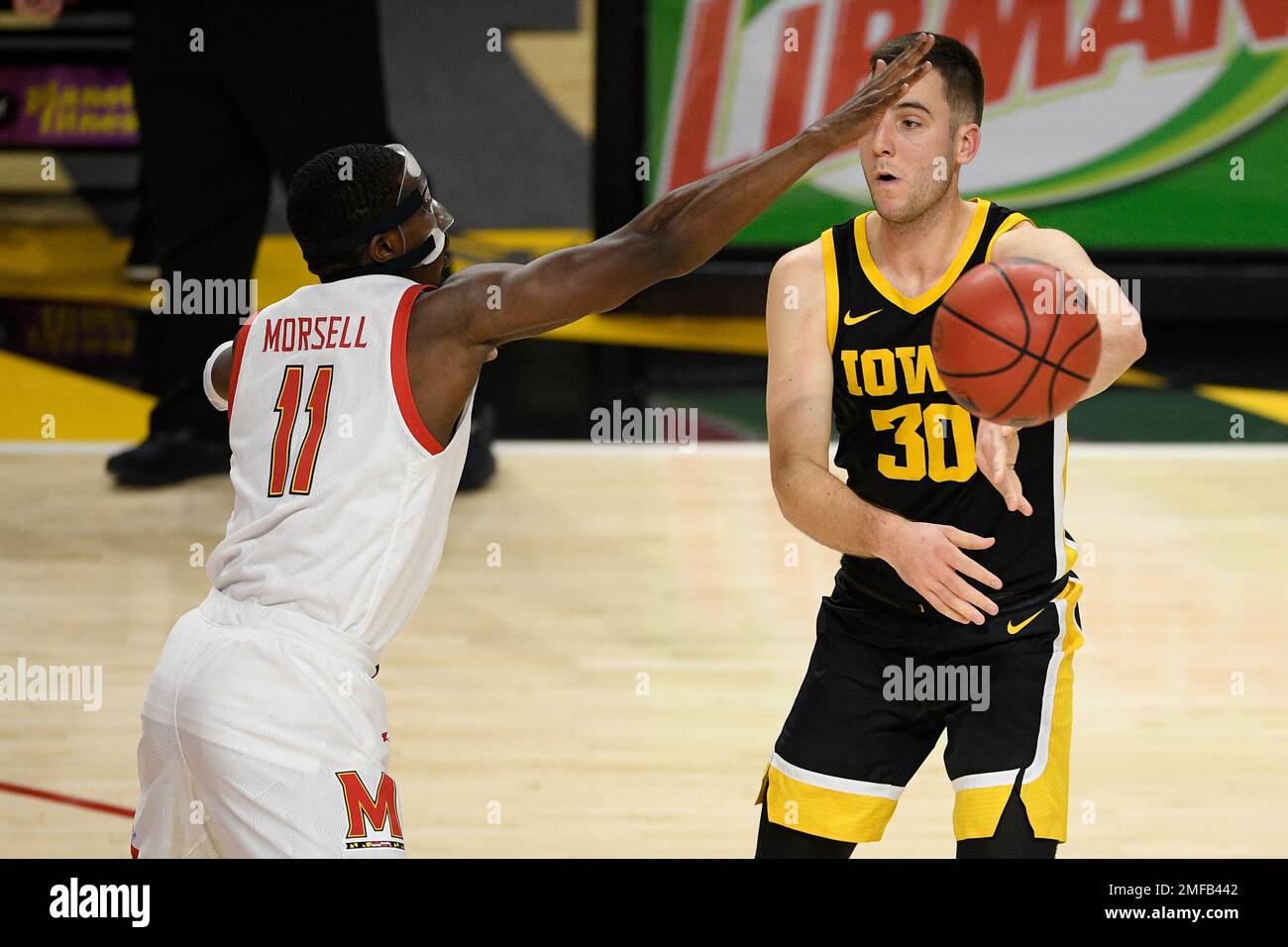 Iowa guard Connor McCaffery (30) passes the ball as he is defended by ...