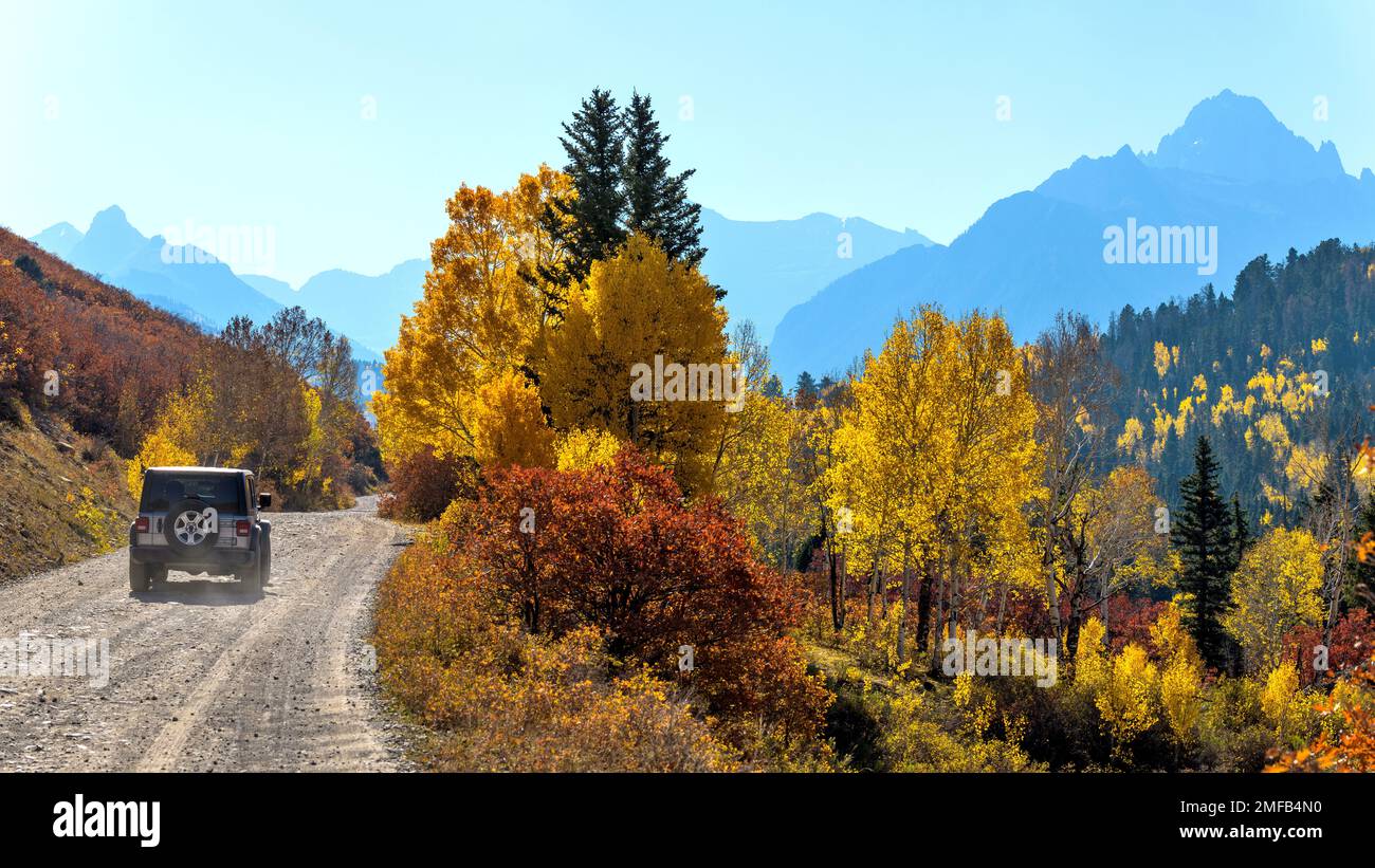 Autumn Drive - A SUV driving on a scenic backcountry road winding ...
