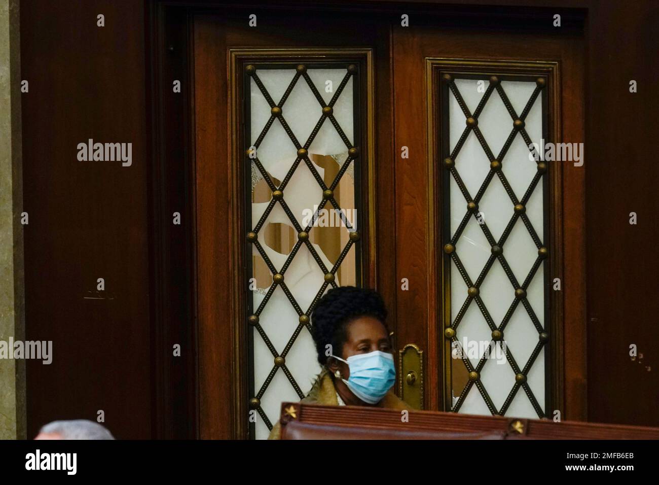 Glass is broken in the doors leading into the House chamber is seen ...