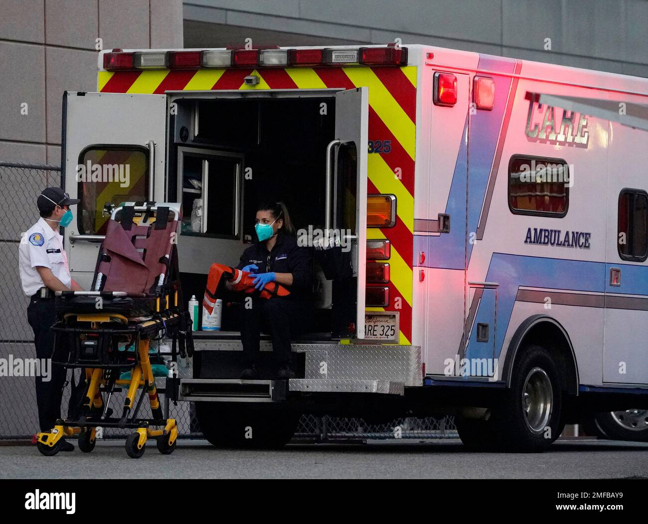 Emergency medical technicians sanitize their ambulance after ...
