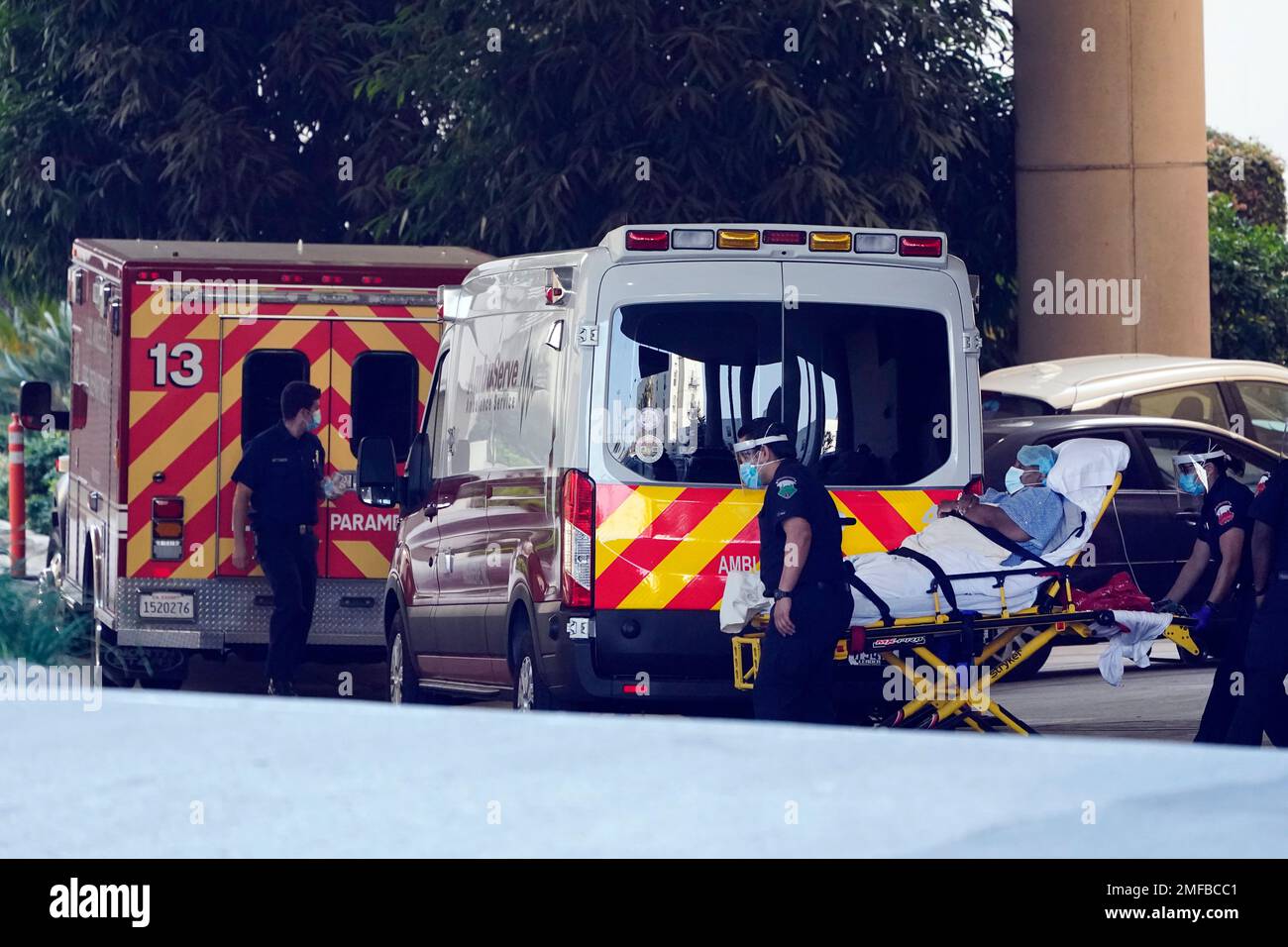 A patient is loaded onto an ambulance outside of the emergency entrance ...