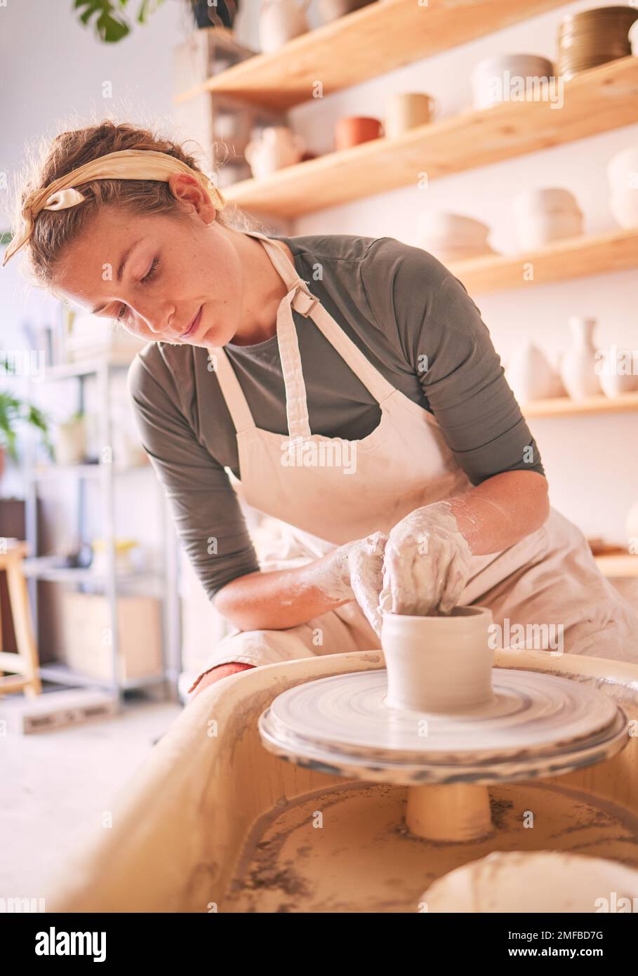 Woman, clay artist and pottery wheel for sculpture design, creative ...