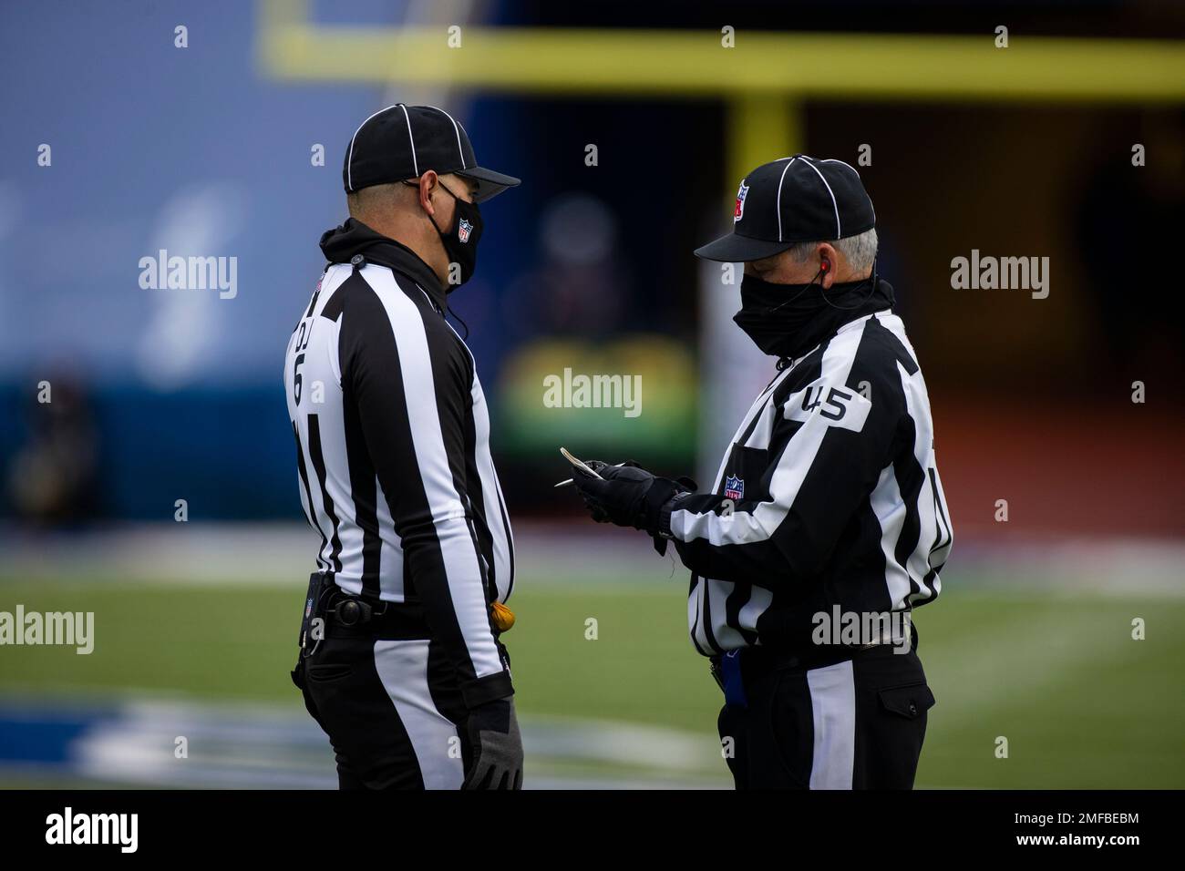 Head linesman Jerod Phillips (6) and line judge Jeff Seeman (45) speak ...