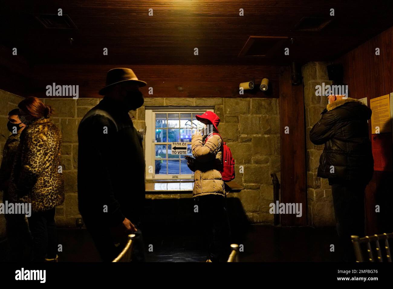 Voters wait in line to cast their ballots in Georgia's Senate runoff ...
