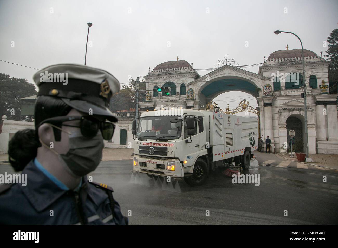 A worker from Kathmandu metropolitan cleans the road as mannequin ...