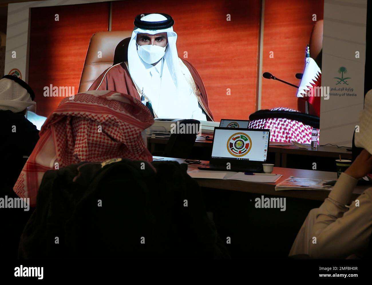 Saudi journalists watch a large display screen in a media center ...
