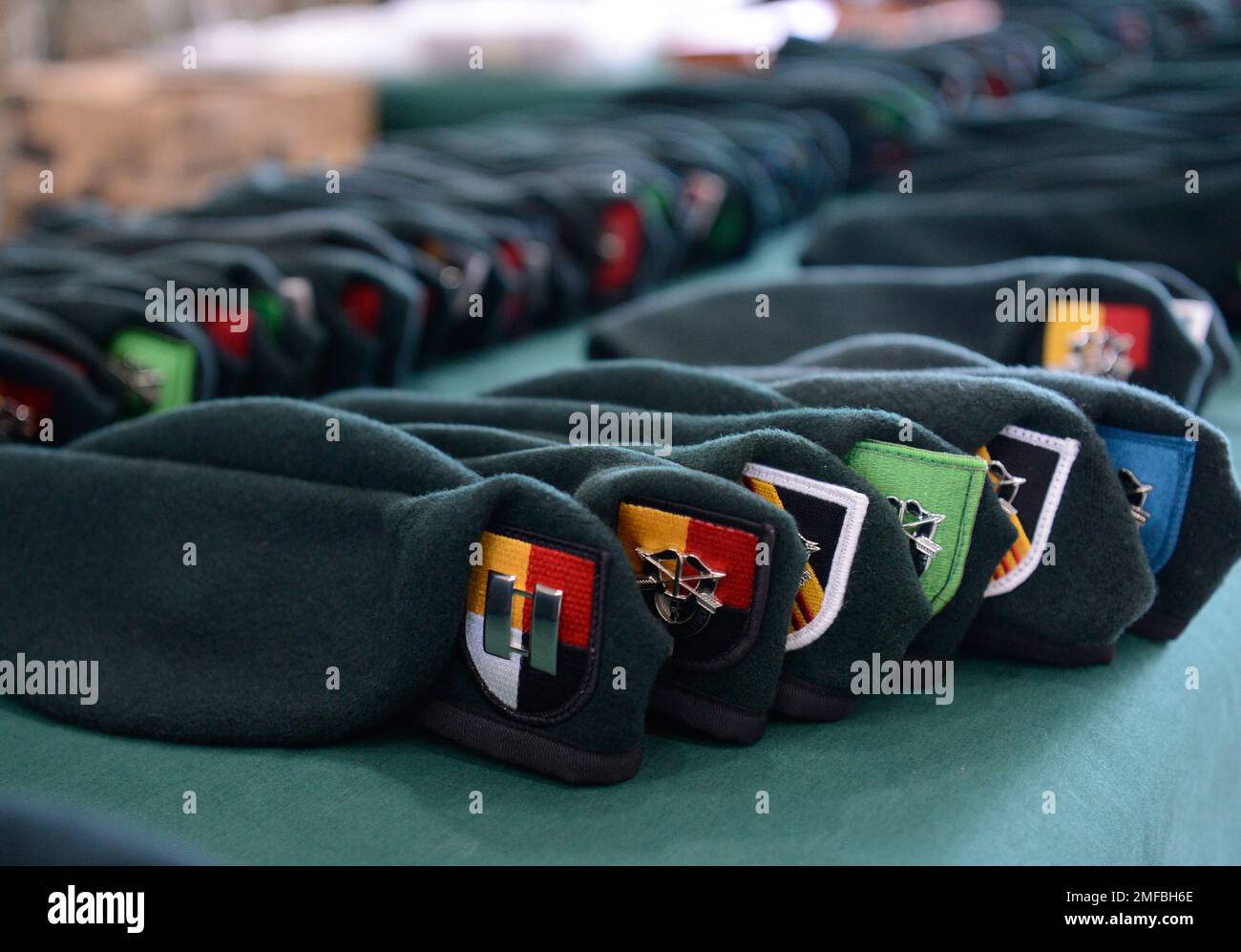 Green berets, are lined up on a table, waiting to being presented to ...