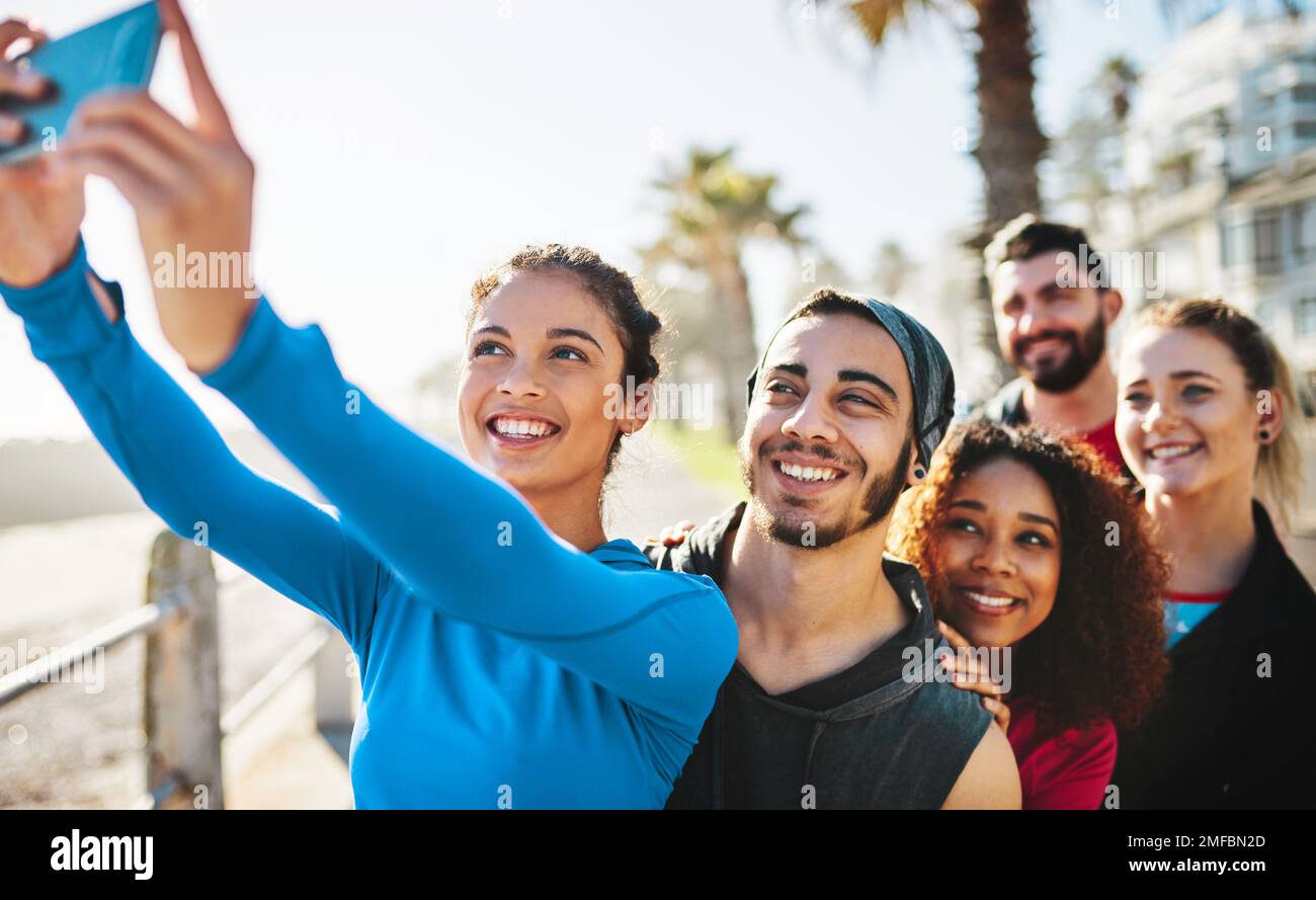 Sport brings people together. a fitness group taking a selfie while out ...