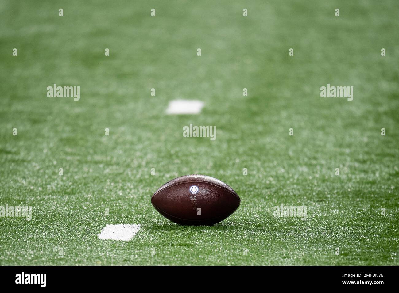 A NFL football with the Indianapolis Colts logo sits on the field ...