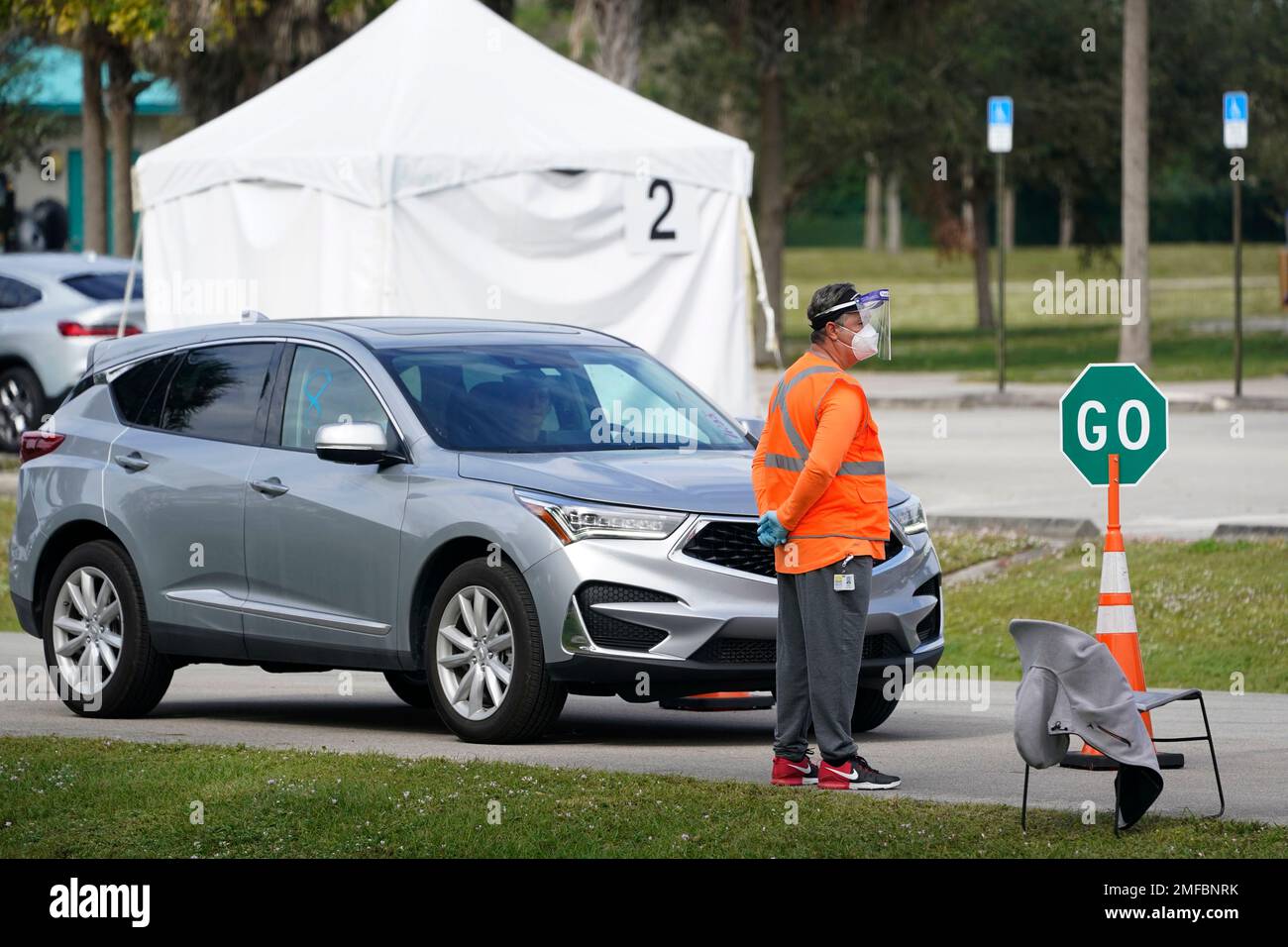 A driver waits at a drive-thru COVID-19 vaccination site, Monday, Jan ...