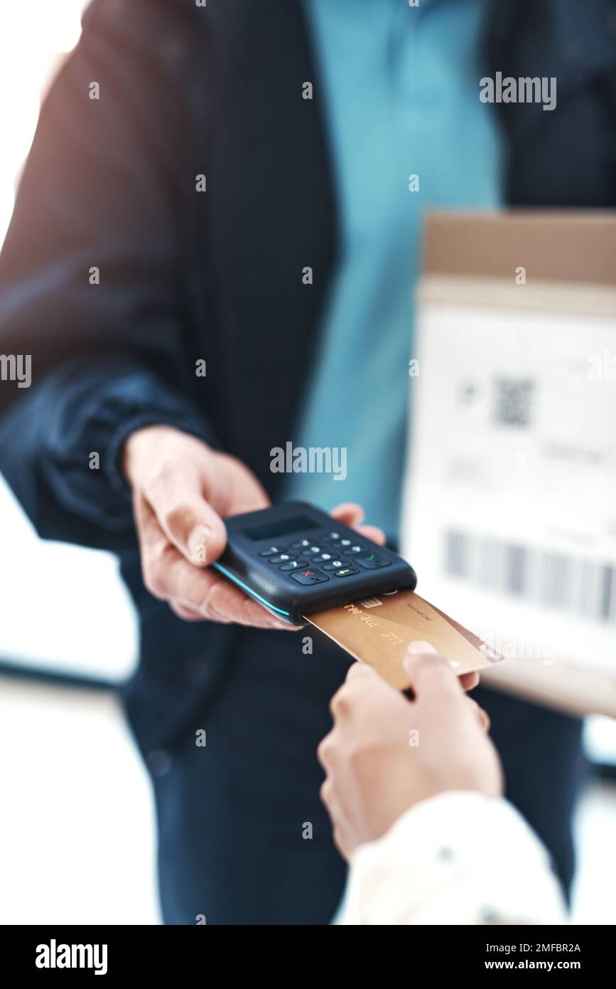 Payment is as easy as that. an unrecognizable delivery man receiving ...