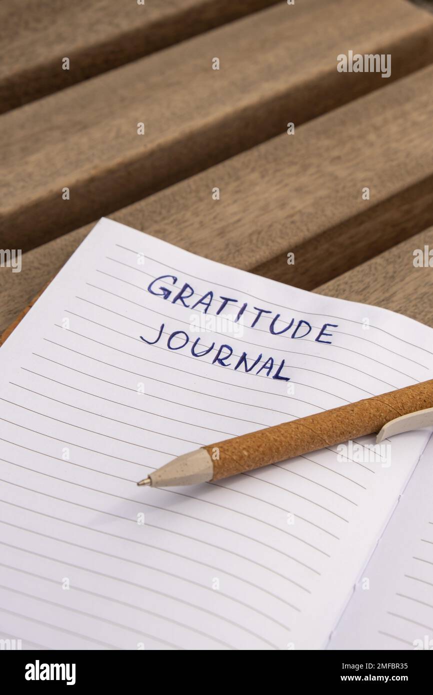 Writing Gratitude Journal on wooden bench. Today I am grateful for ...